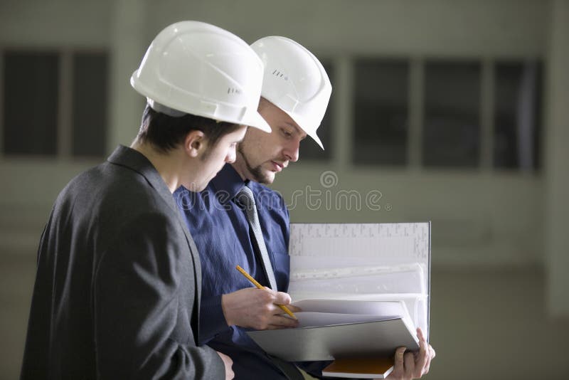 Architects Going through File Folder in Warehouse Stock Photo - Image ...