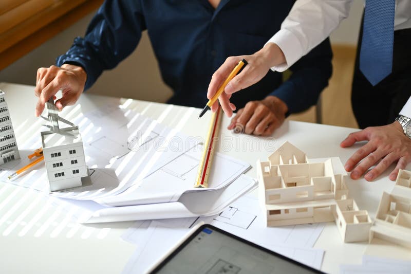 Architects Man Reviewing Blueprints Working on Sketch of a New ...