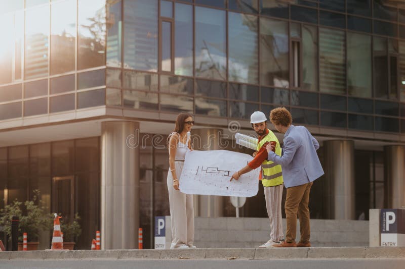 Architects Reviewing Drawings and Blueprint, Emphasizing Teamwork and ...