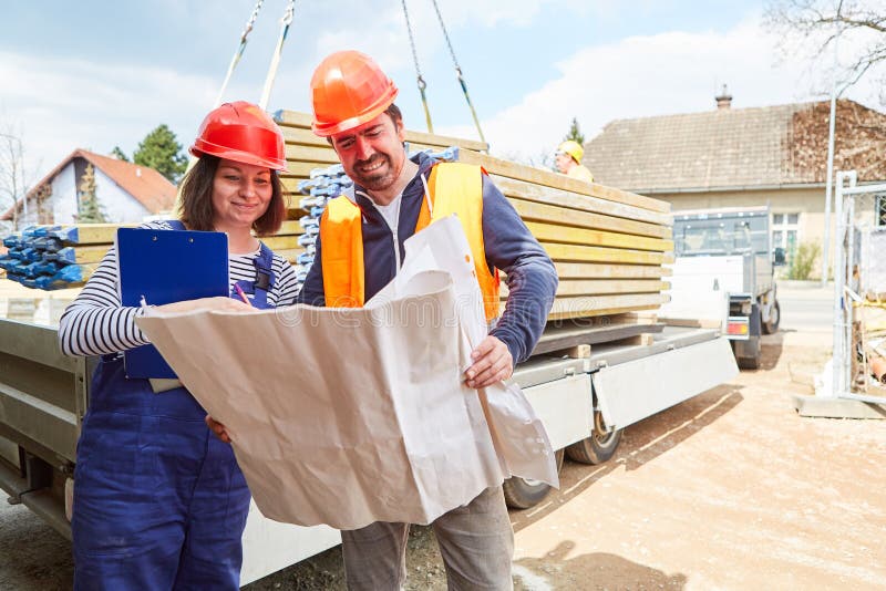 Architects Team with Blueprint in Front of Truck with Material Stock ...