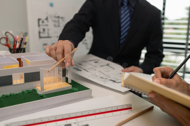 Architects Work with Engineers and Contractors in the Office To Check ...