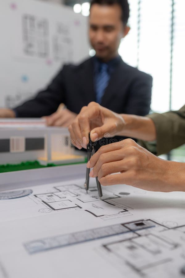 Architects Work with Engineers and Contractors in the Office To Check ...