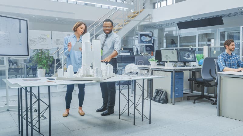 In Architectural Bureau: Architect and Engineer Talking, Working on a ...