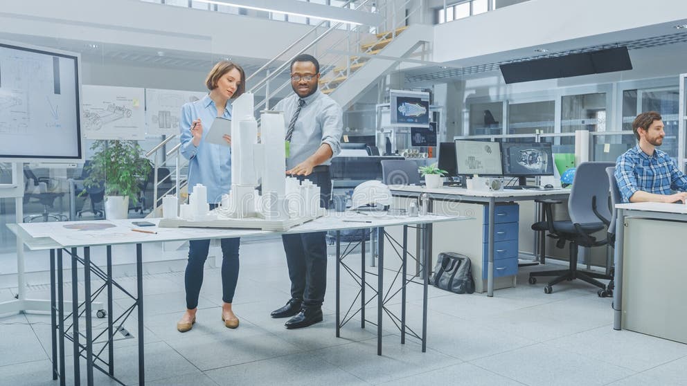 In Architectural Bureau: Architect and Engineer Talking, Working on a ...