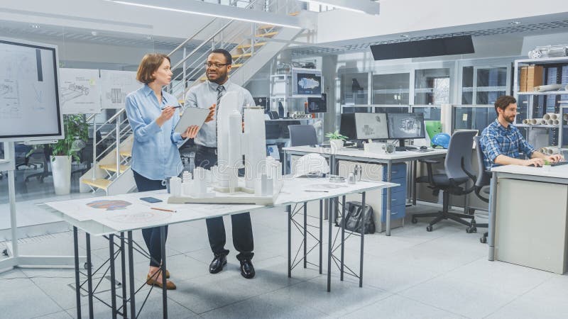 In Architectural Bureau: Team of Architects and Engineers Working on a ...