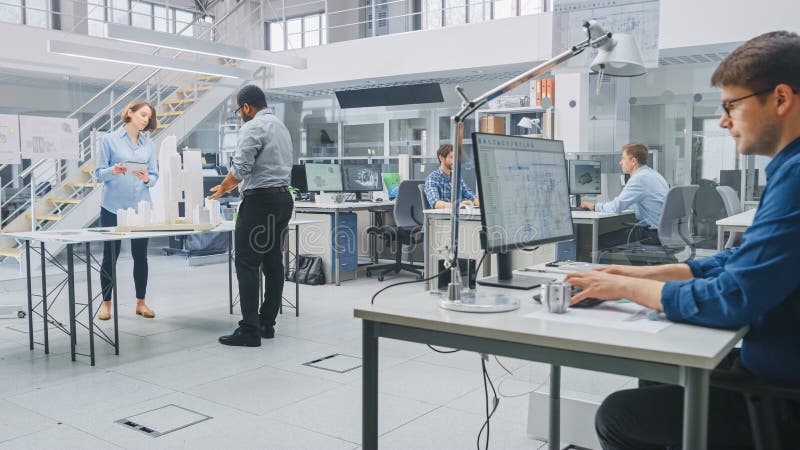 In Architectural Bureau: Team of Architects and Engineers Working on a ...