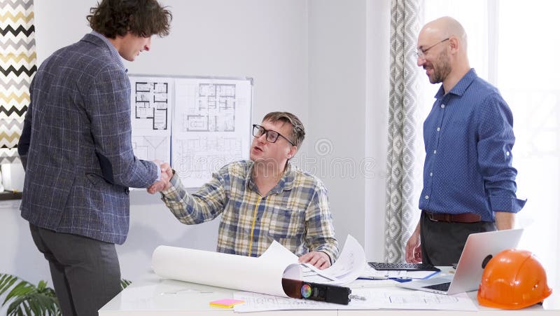 Architectural Bureau. Three Men Shake Hands in the Office of the Chief ...