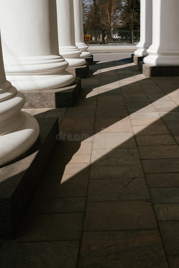 Architectural Columns Casting Shadows on Pavement Stock Image - Image ...