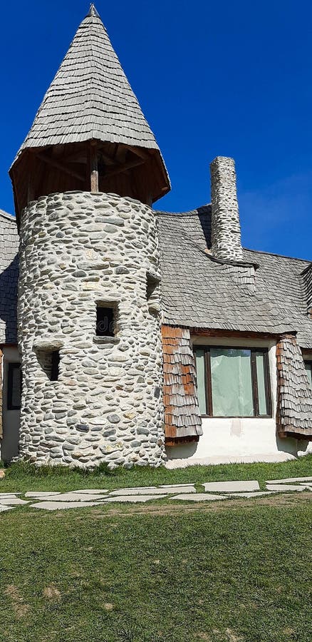 Architectural Details of a Building with a Stone Tower and a Shingle ...