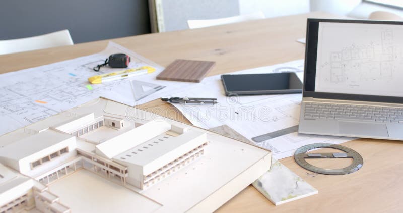 Architectural Model and Blueprints on Desk with Laptop and Tablet ...