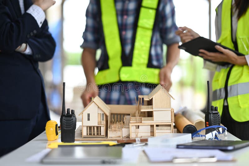 Architectural Model of a House with Blueprint and Tools on Table ...
