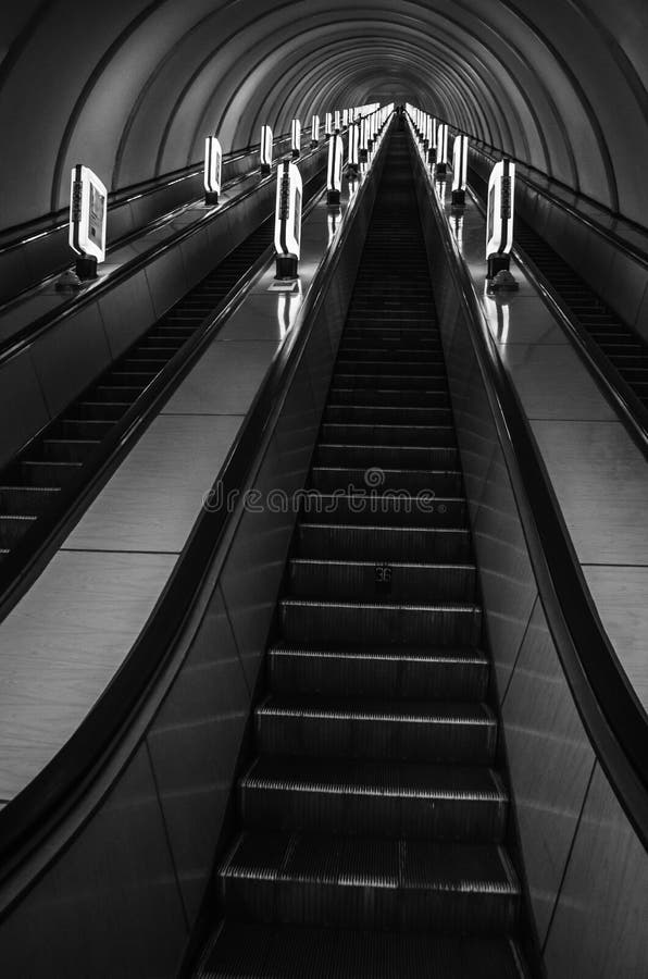 Rise on the Escalator in the Subway. Light Boxes Along the Tunnel Stock ...