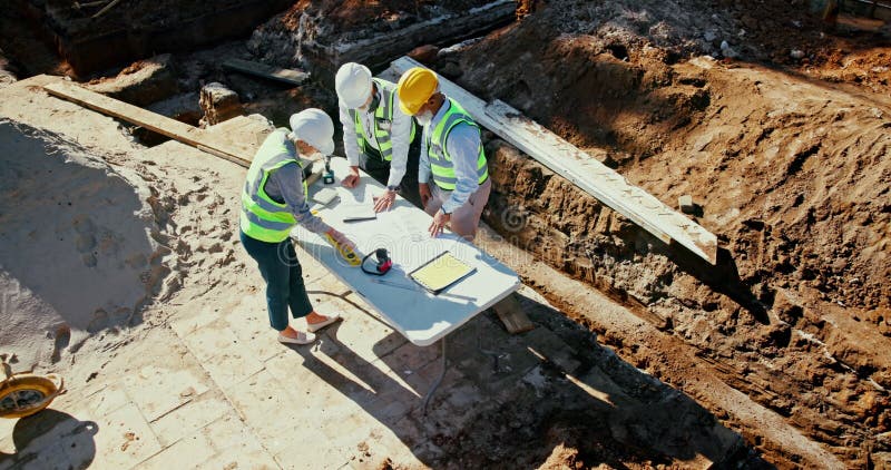 Men, Architecture and Blueprint for Discussion in Warehouse ...