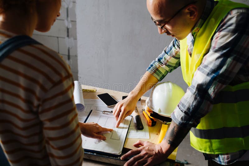 Arguing Engineering Team Going Over a Blueprint, Looking for Solutions ...