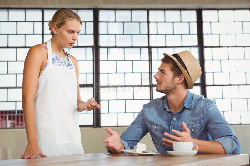 Argument between a Waitress and a Client Stock Photo - Image of adult ...