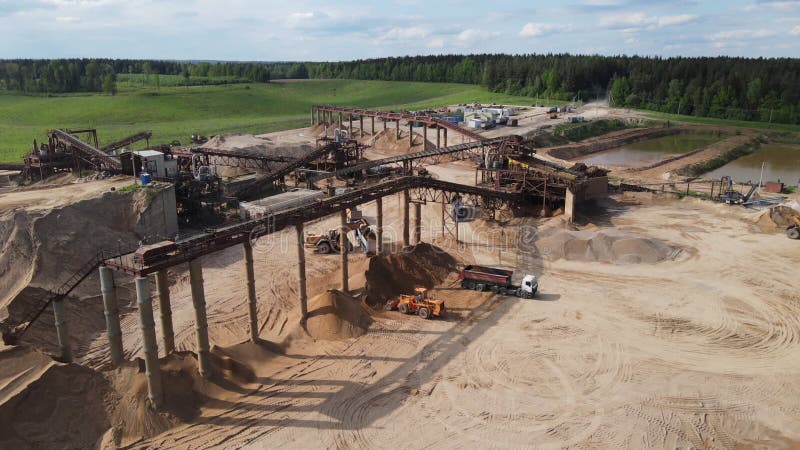 Wheel Loader Loading Sand into Dump Truck in Opencast Quarry. Truck ...