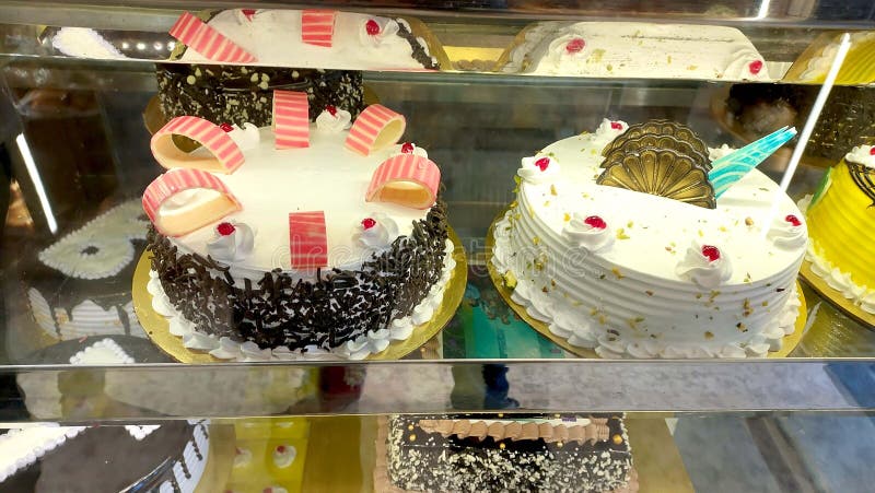 Arious Cake with Icing in Refrigerated Bakery Case Cabinet - Image ...