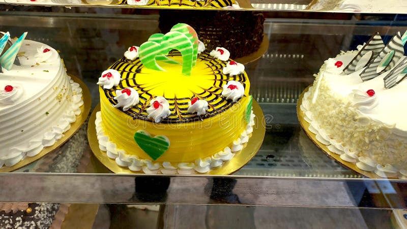 Arious Cake with Icing in Refrigerated Bakery Case Cabinet - Image ...