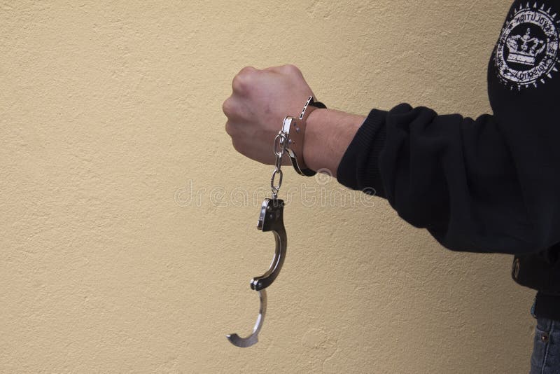 Arm and Hand with Handcuffs Hanging Stock Image - Image of arrest ...
