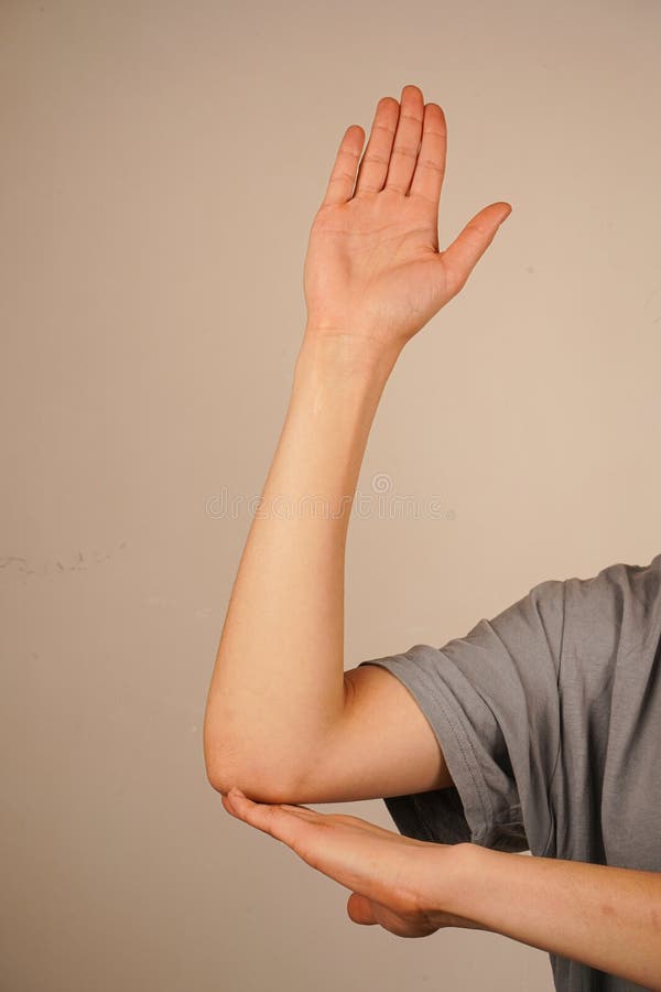 The Arm is Raised with an Open Gesture, Supported by the Opposite Hand ...