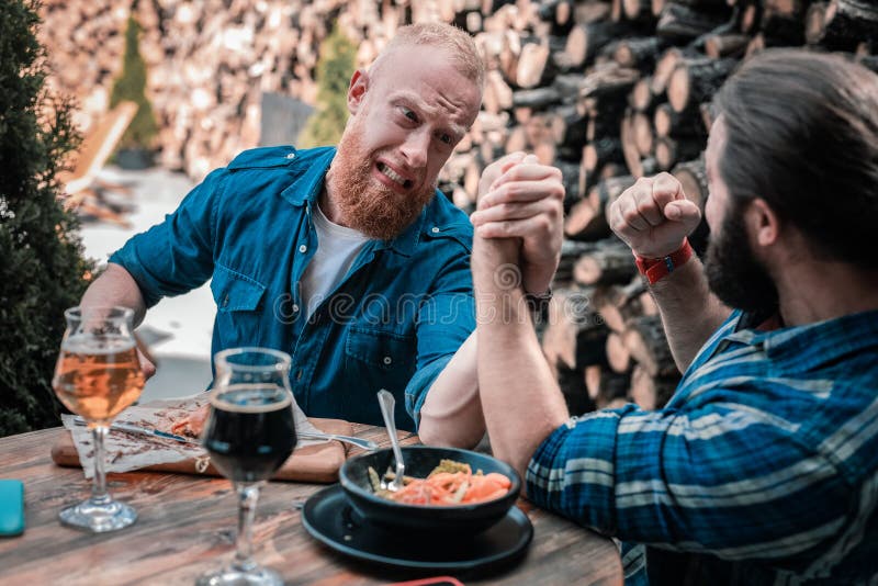 Bearded Men Arm Wrestling while Drinking Beer Together Stock Image ...