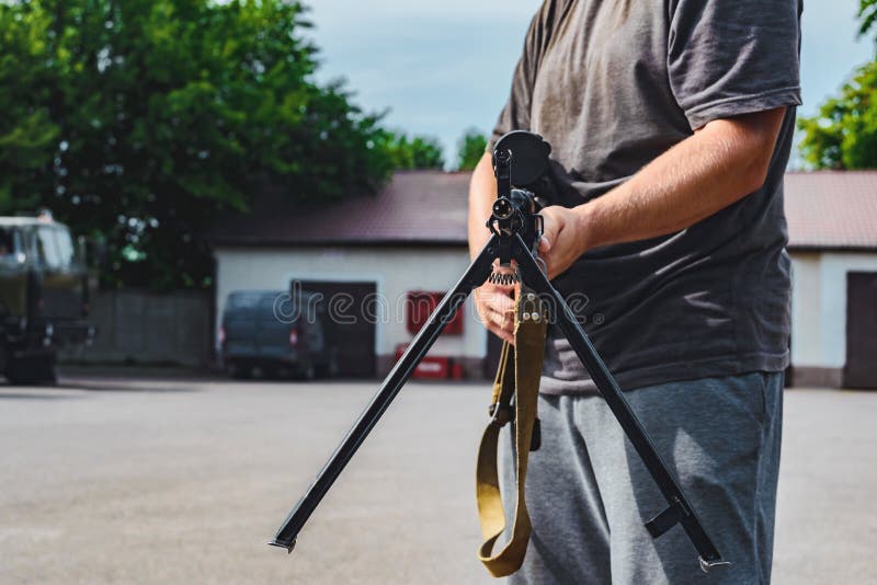 Armed Man with a Sniper Machine Gun Military Weapon in the Hands of a ...
