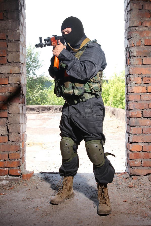 Armed Soldier in Black Mask Targeting with a Gun Stock Photo - Image of ...