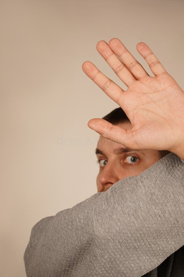 With Arms Crossed and Fingers Spread Wide, a Man Creates a Gesture of ...