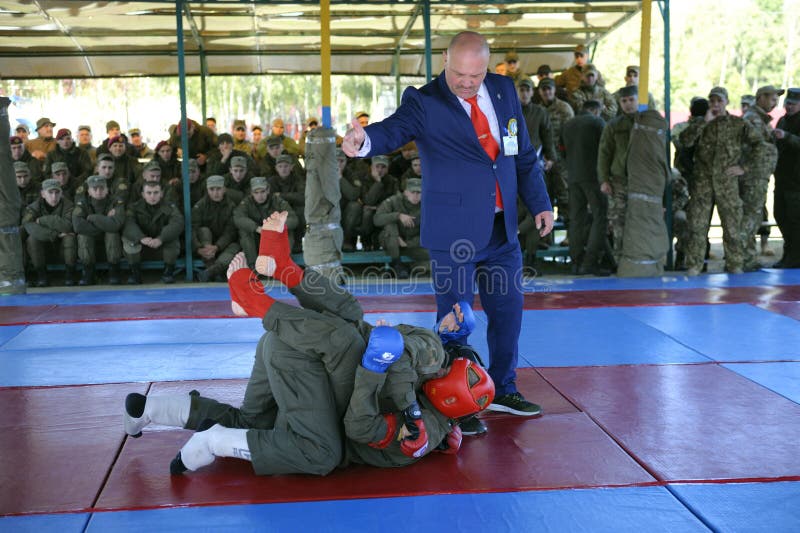 Army Combative. Two Fighters Fighting in a Ring, Referee Watching ...