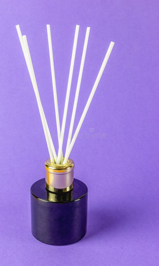 Aromatic Diffuser Sticks in a Black Bottle on a Purple Background Stock ...