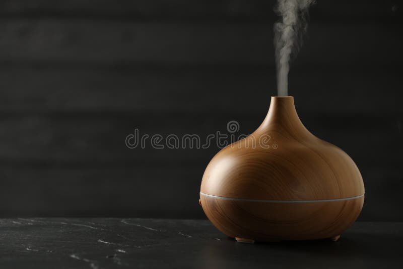 Aroma Oil Diffuser on Black Table, Space for Text Stock Image - Image ...