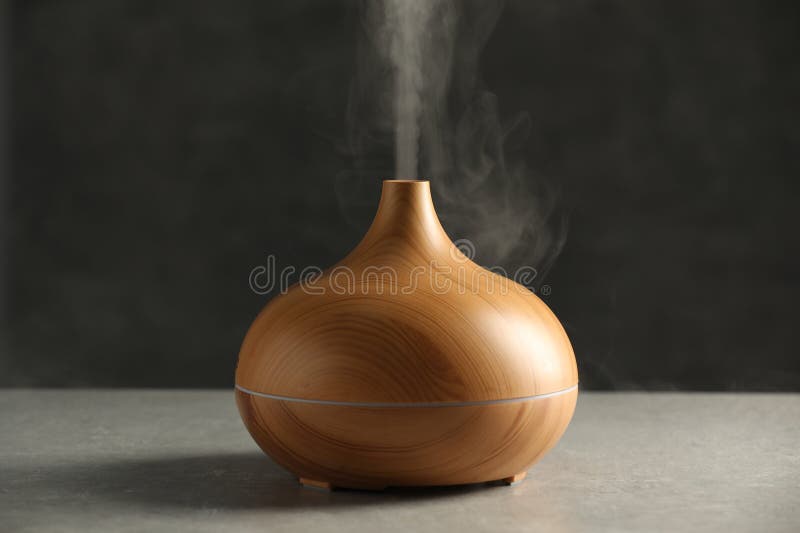 Aroma Oil Diffuser with Steam on Light Grey Table Stock Illustration ...