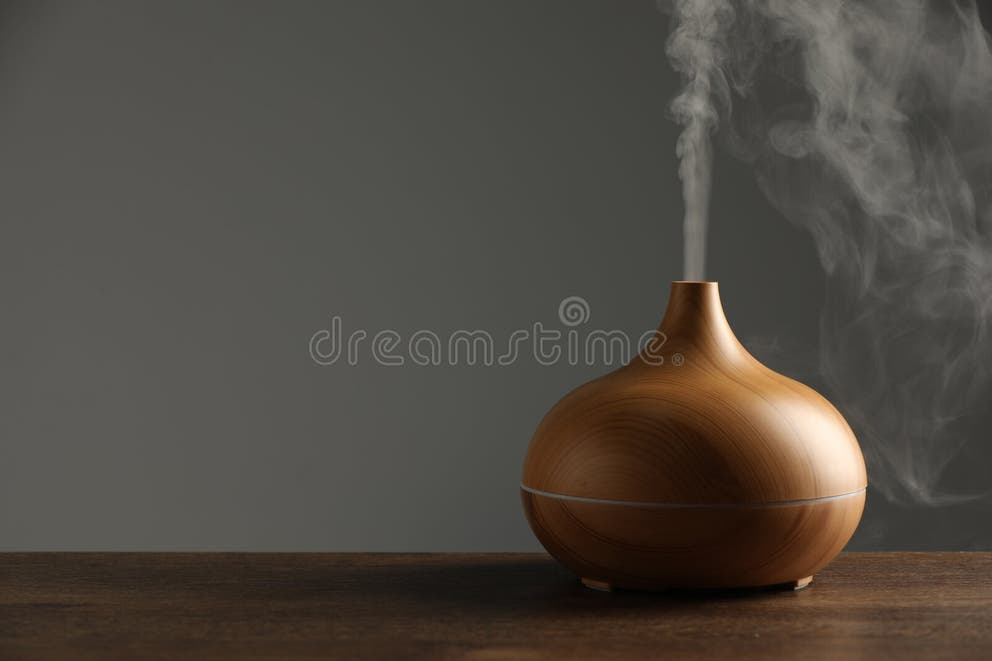 Aroma Oil Diffuser with Steam on Wooden Table, Space for Text Stock ...