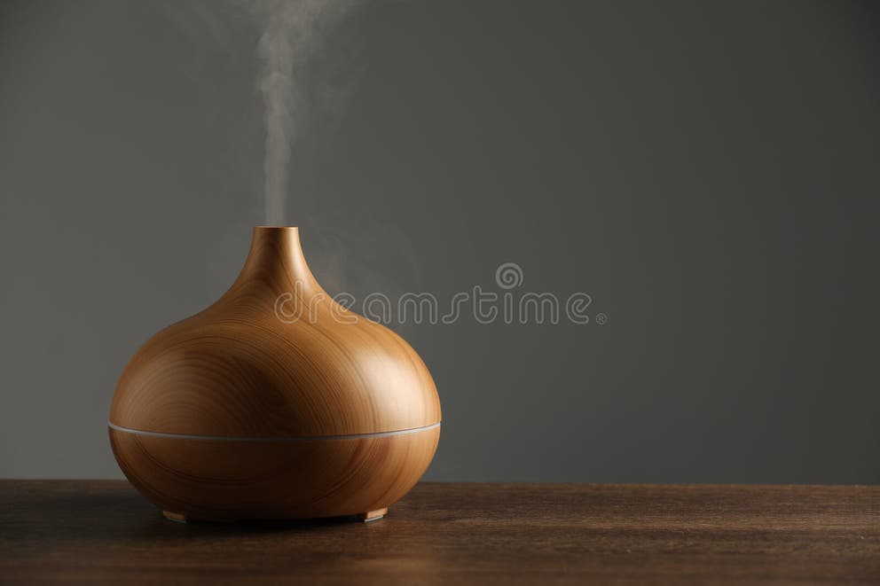 Aroma Oil Diffuser with Steam on Wooden Table, Space for Text Stock ...
