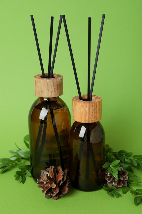 Aroma Scent Diffusers, Cones and Leaves on Green Background Stock Photo ...