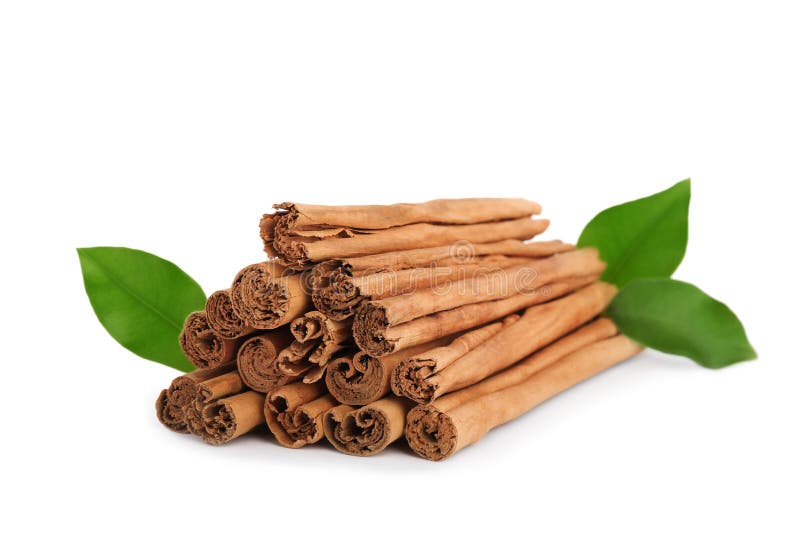 Aromatic Dry Cinnamon Sticks and Green Leaves on White Background Stock ...