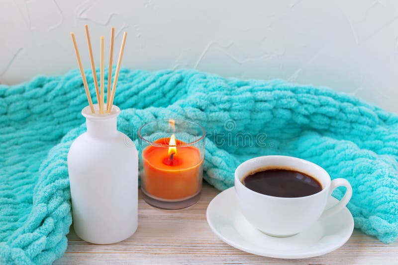 Aromatic Reed Diffuser, a Cup of Coffee, a Candle and a Blanket on a ...