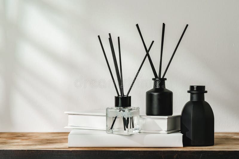 Aromatic Reed Diffuser on White Books with Shadows Playing on the Wall ...