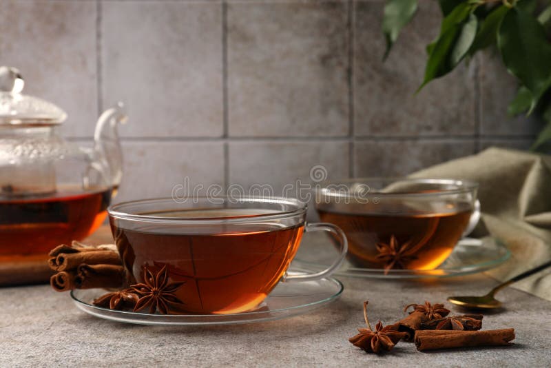 Aromatic Tea with Anise Stars and Cinnamon Sticks on Light Grey Table ...