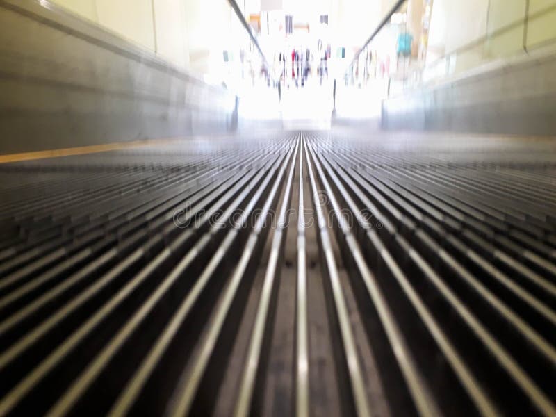 Looking Along a Descending Escalator, with Objects Around the Escalator ...
