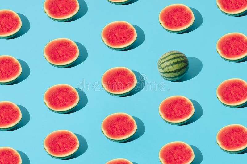 Arranged Half Watermelon and One Whole on a Blue Pastel Background ...