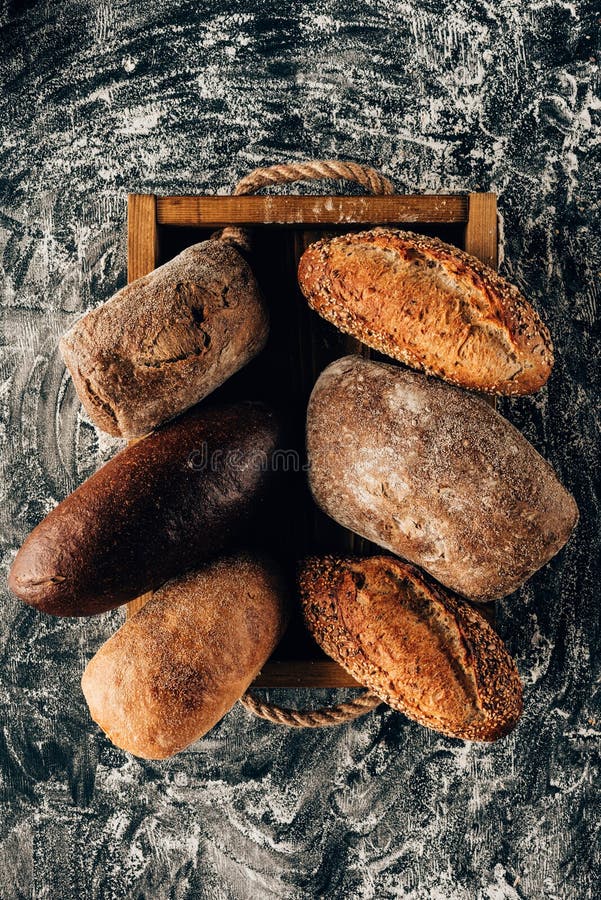 Arranged Loafs of Bread in Wooden Box on Dark Tabletop with Flour Stock ...