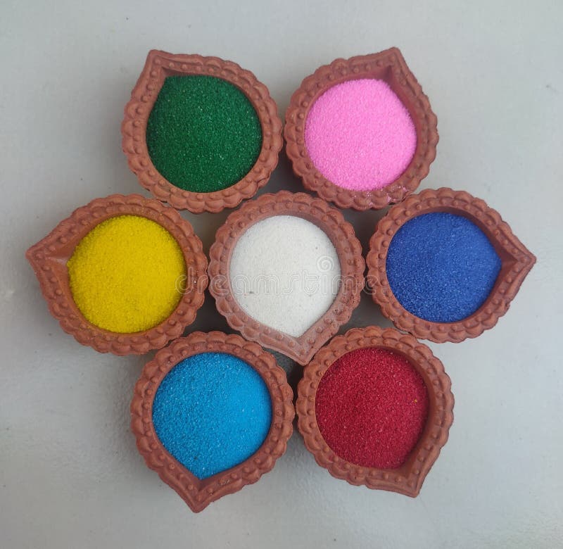 Arrangement of Beautiful Rangoli Colors in Earthen Diya in Circle ...