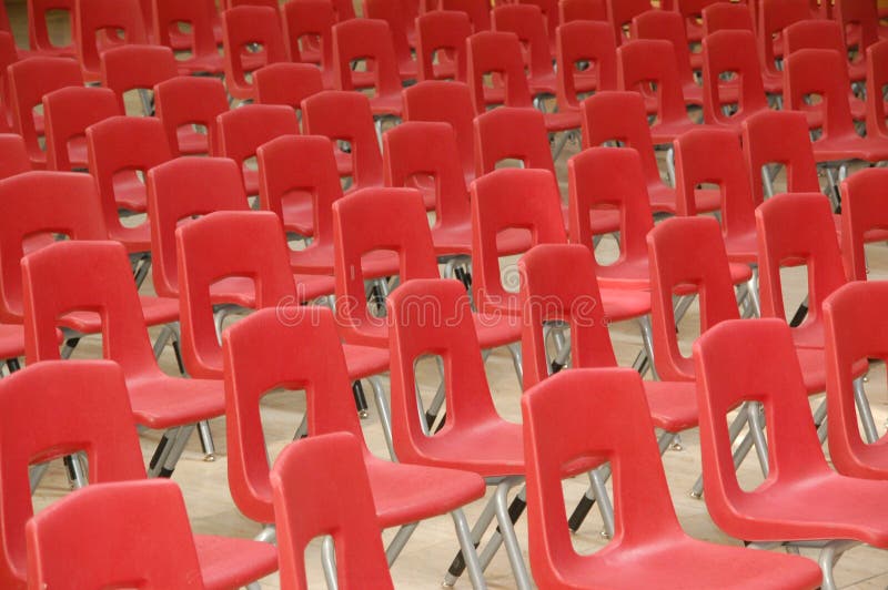Arrangement of red chairs stock image. Image of audience - 3480945