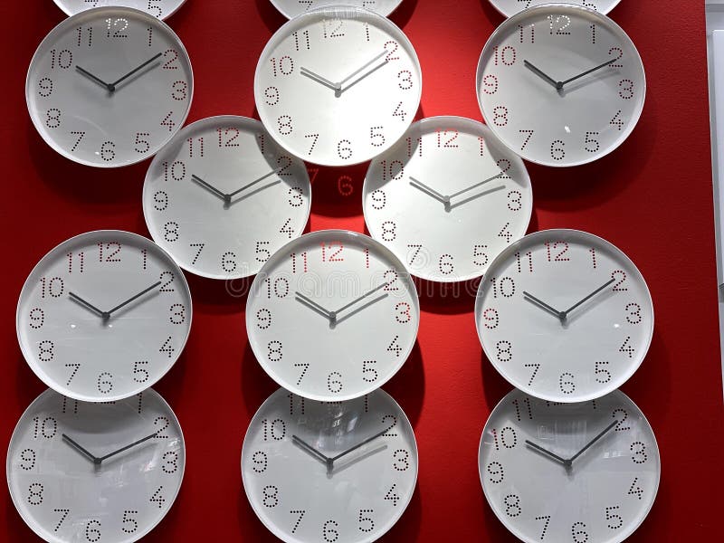 Arrangements of Glossy White Clocks on a Red Wall Stock Photo - Image ...
