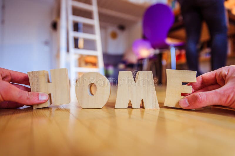 New Home: Arranging HOME Letters Stock Photo - Image of hand, homely ...