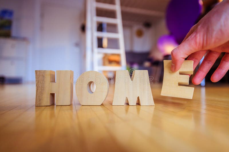 New Home: Arranging HOME Letters Stock Photo - Image of hand, homely ...
