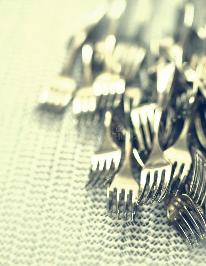 Lots of forks on the table stock photo. Image of pile - 124362434