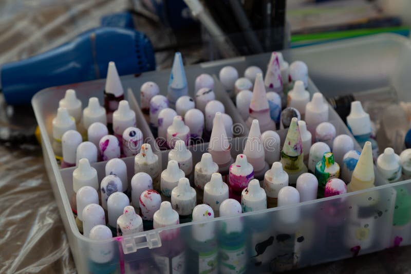 Array of Colorful, Used Ink Bottles with Assorted Caps in a Plastic ...