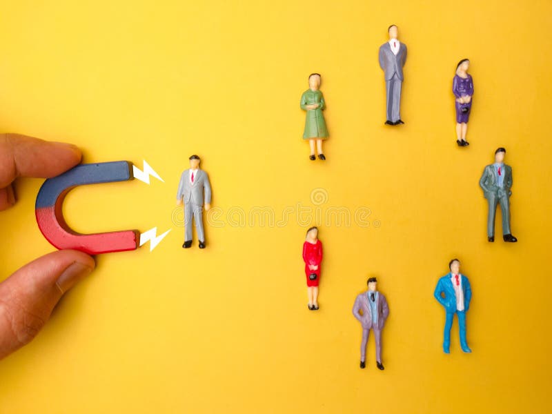 Array of Figurines Arranged in a Pattern with a Magnet and an Arrow ...